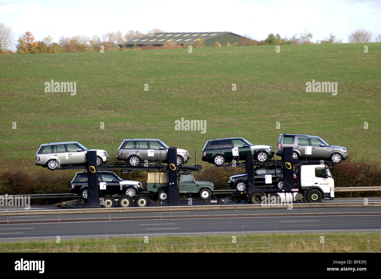 Newly built Land Rover cars on Autologic transporter on M40 motorway ...