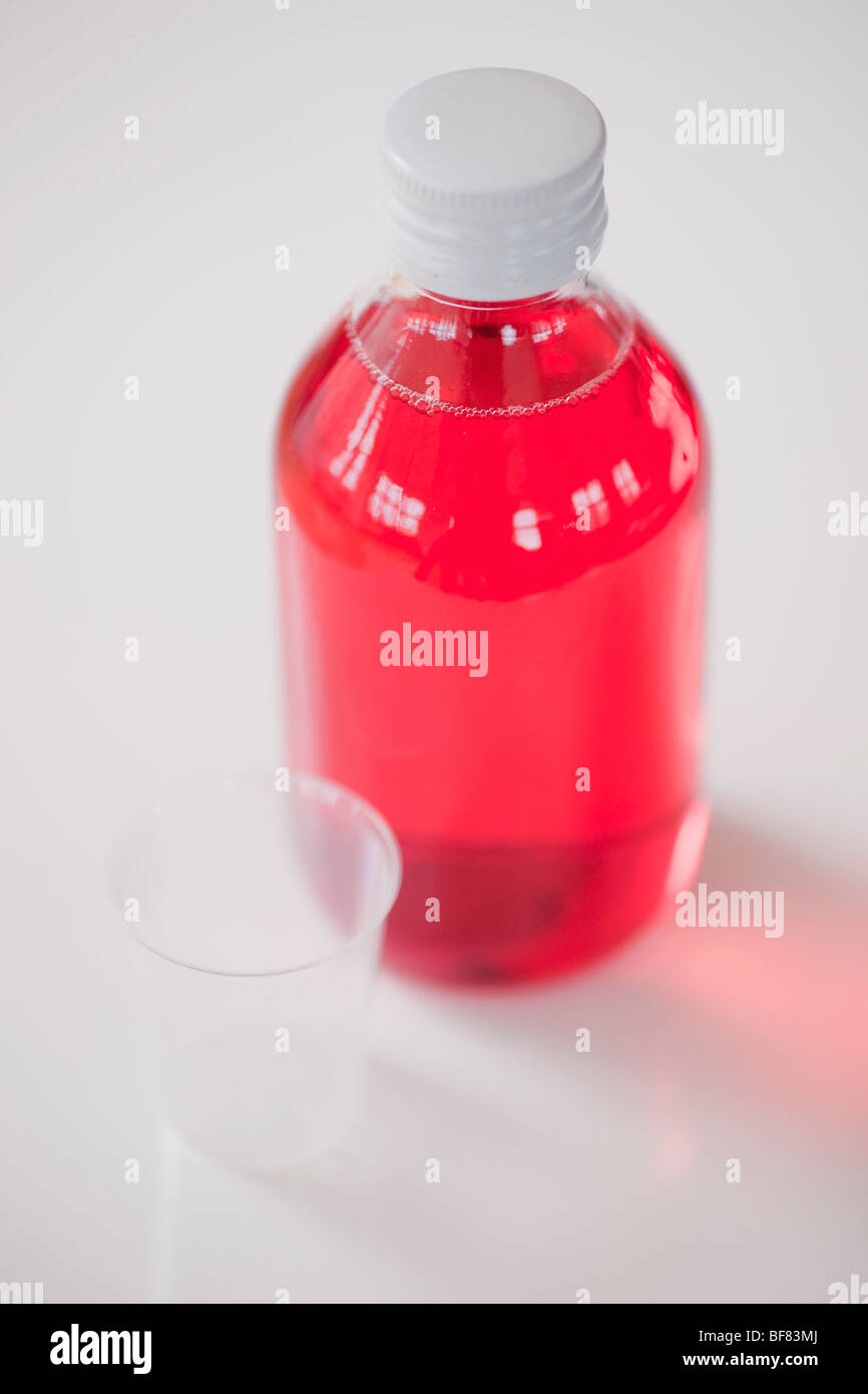 bottle of medicine and dose cap Stock Photo - Alamy