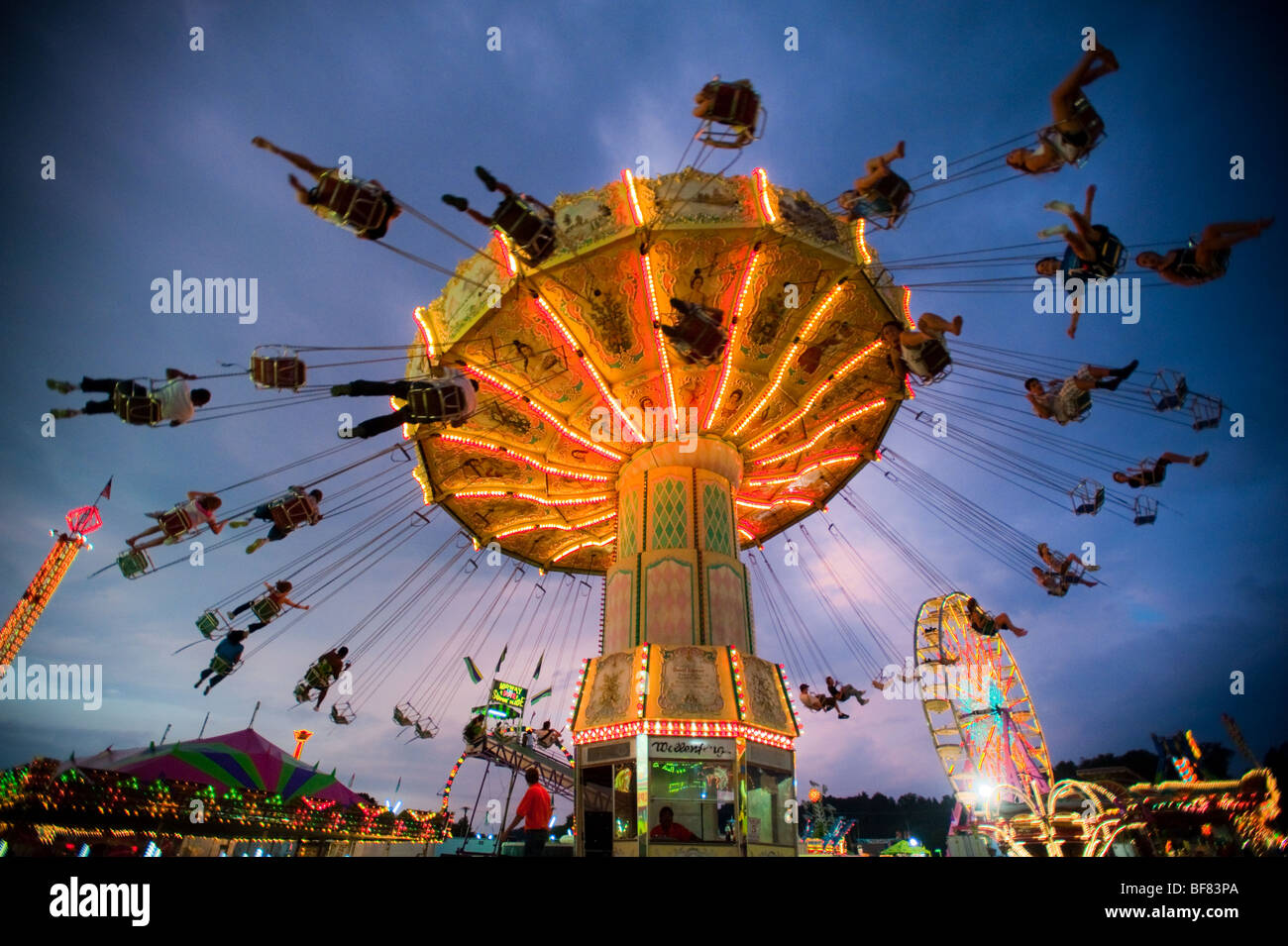 Swinger midway rids at State Fair at dusk Stock Photo - Alamy
