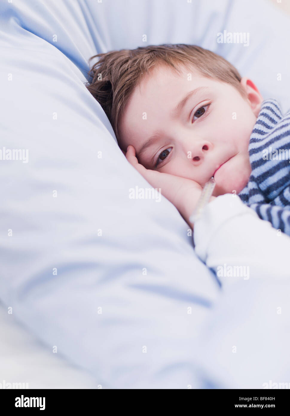 boy in bed looking at viewer Stock Photo - Alamy