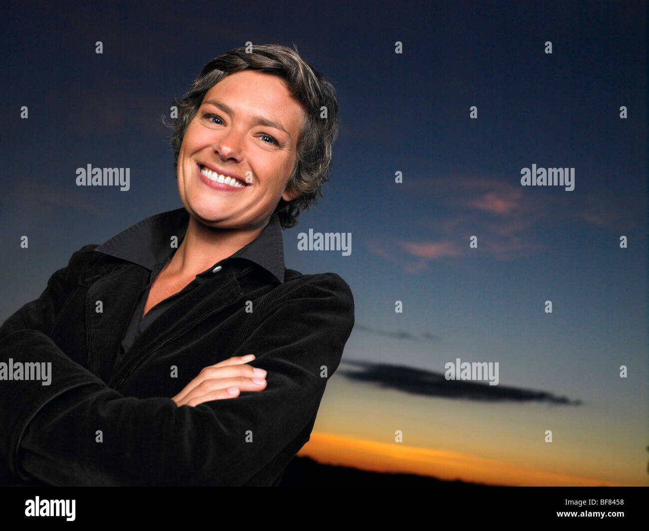 Woman smiling by night, outdoors Stock Photo - Alamy