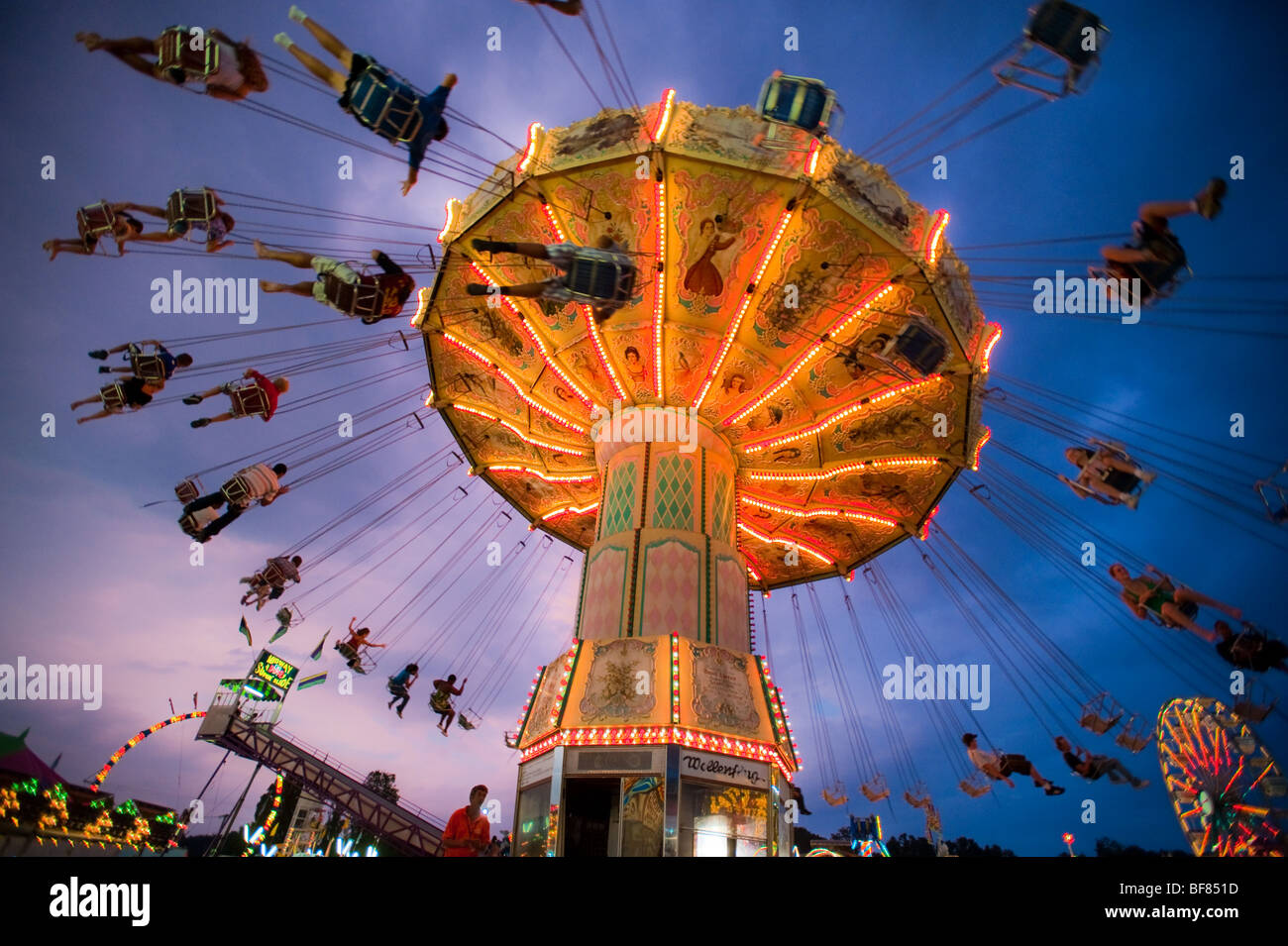 Swinger midway rids at State Fair at dusk Stock Photo - Alamy