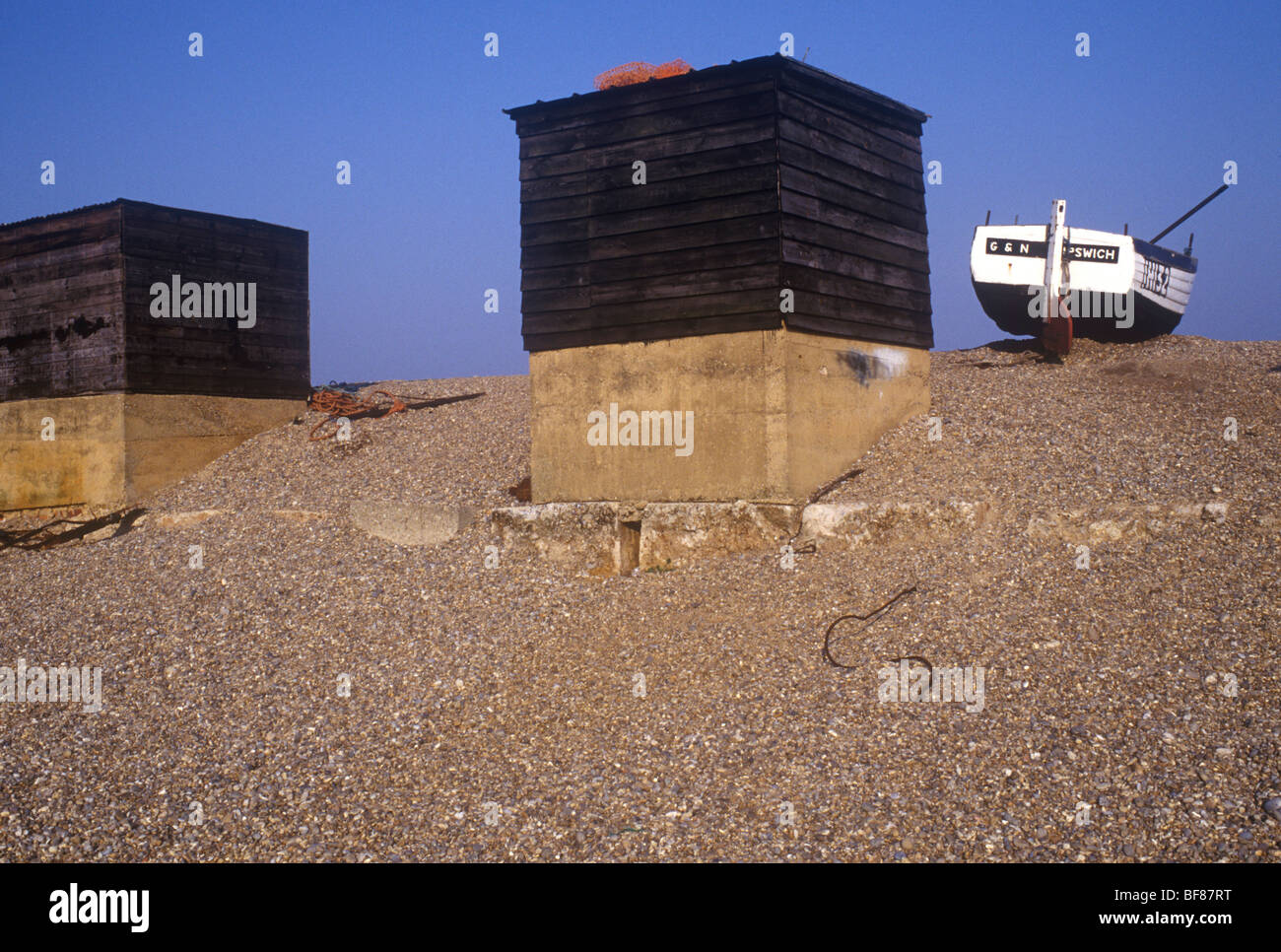 Dunwich Suffolk UK Steep shingle beach with fishing boat black ...