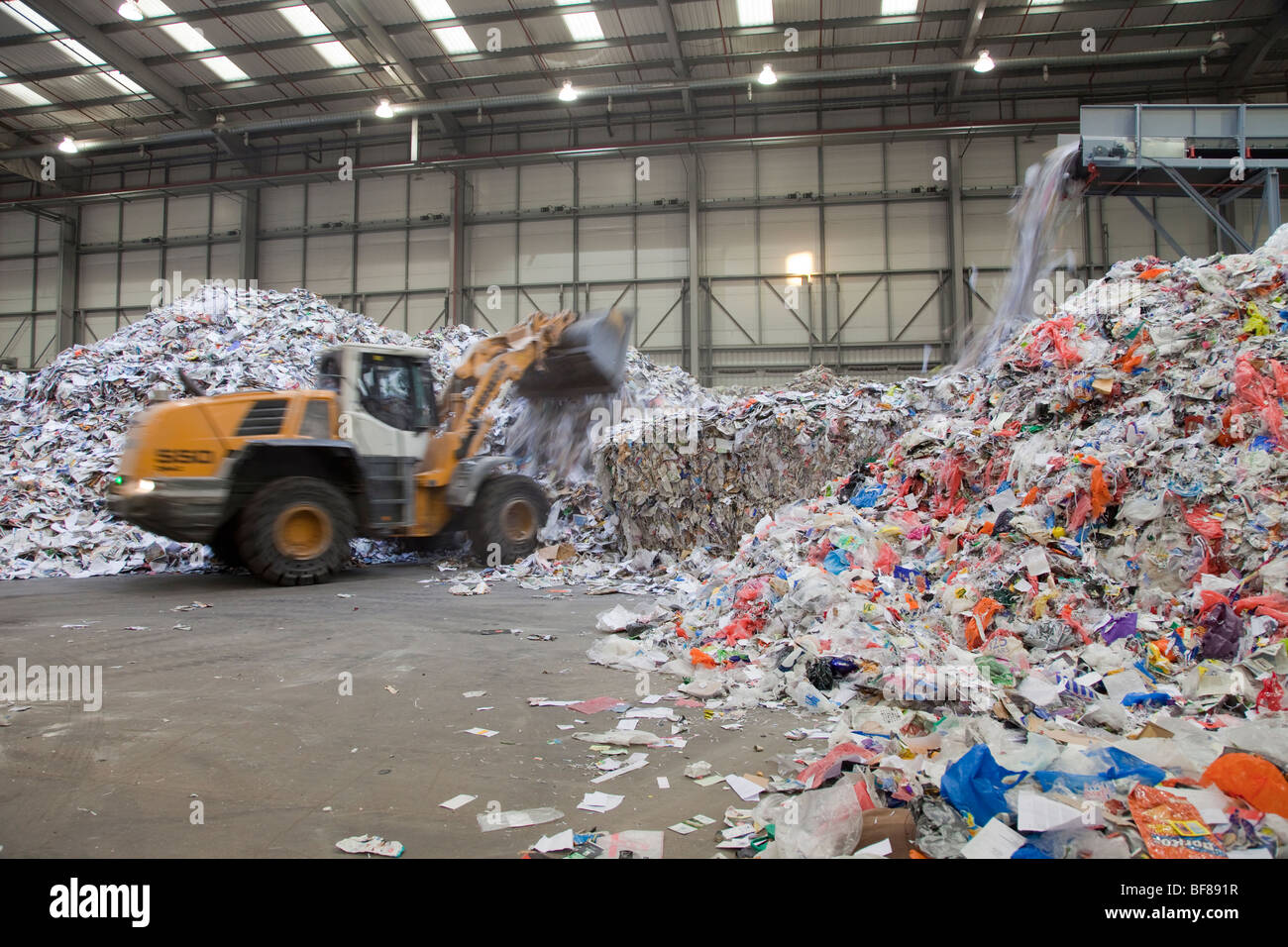 Bulldozer moving in paper plastic recycling factory Stock Photo - Alamy Bulldozer moving in paper plastic recycling factory Stock Photo - Alamy