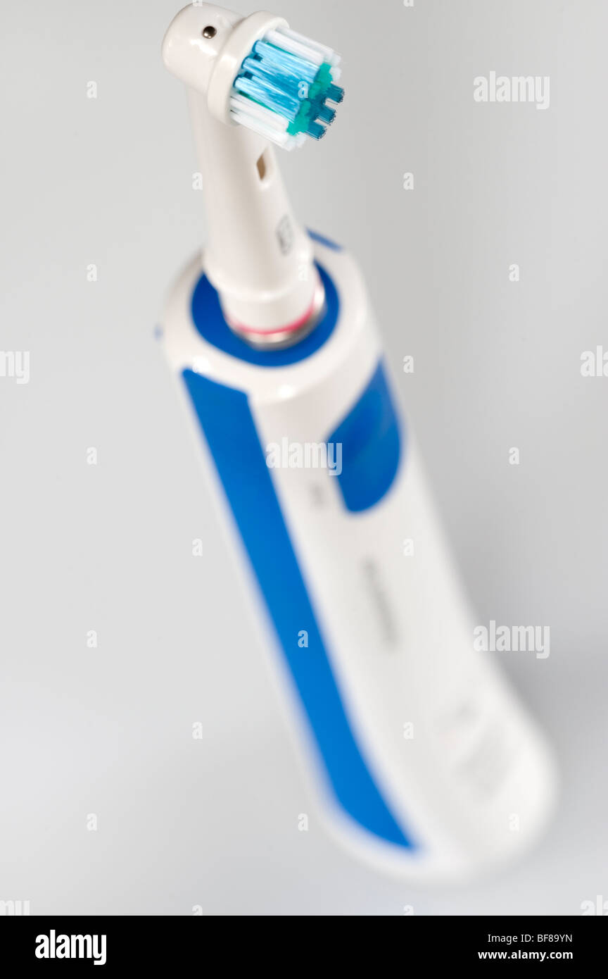 White and blue electric toothbrush Stock Photo - Alamy