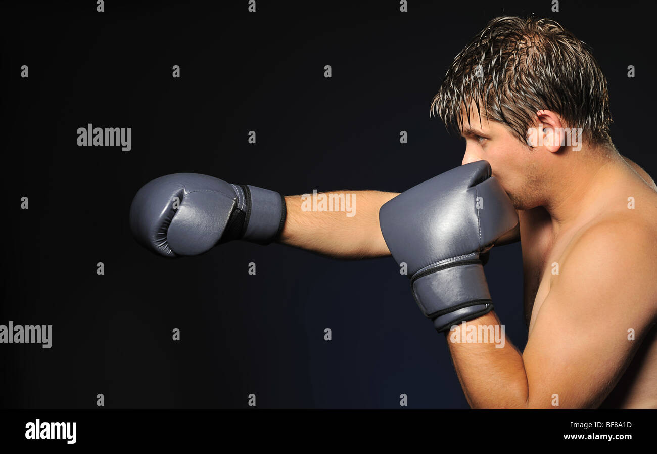 The boxer. The young man in boxing gloves Stock Photo - Alamy