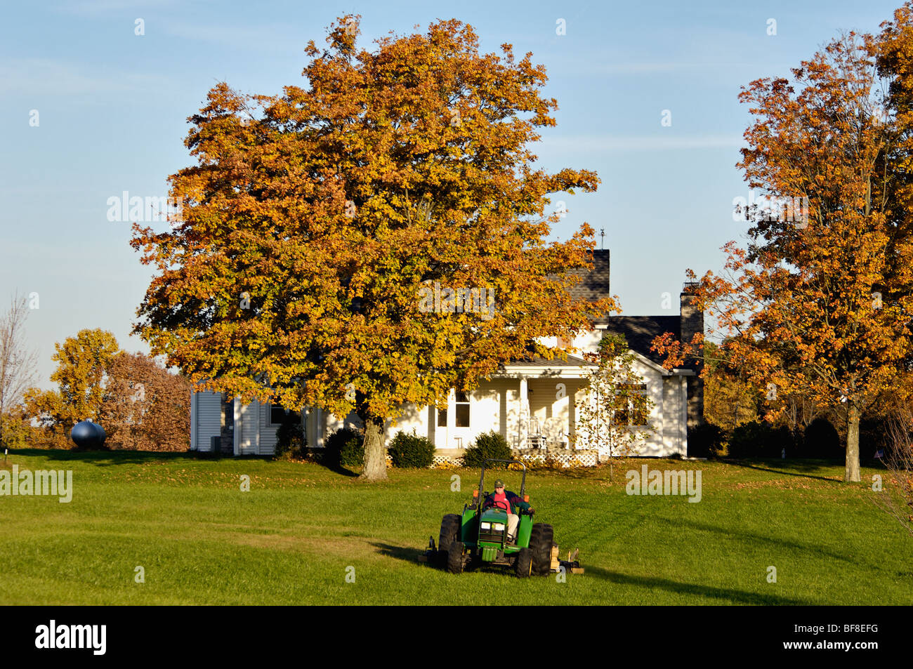 Man Mowing Large Yard at Rural Home with John Deere Tractor in Floyd ...
