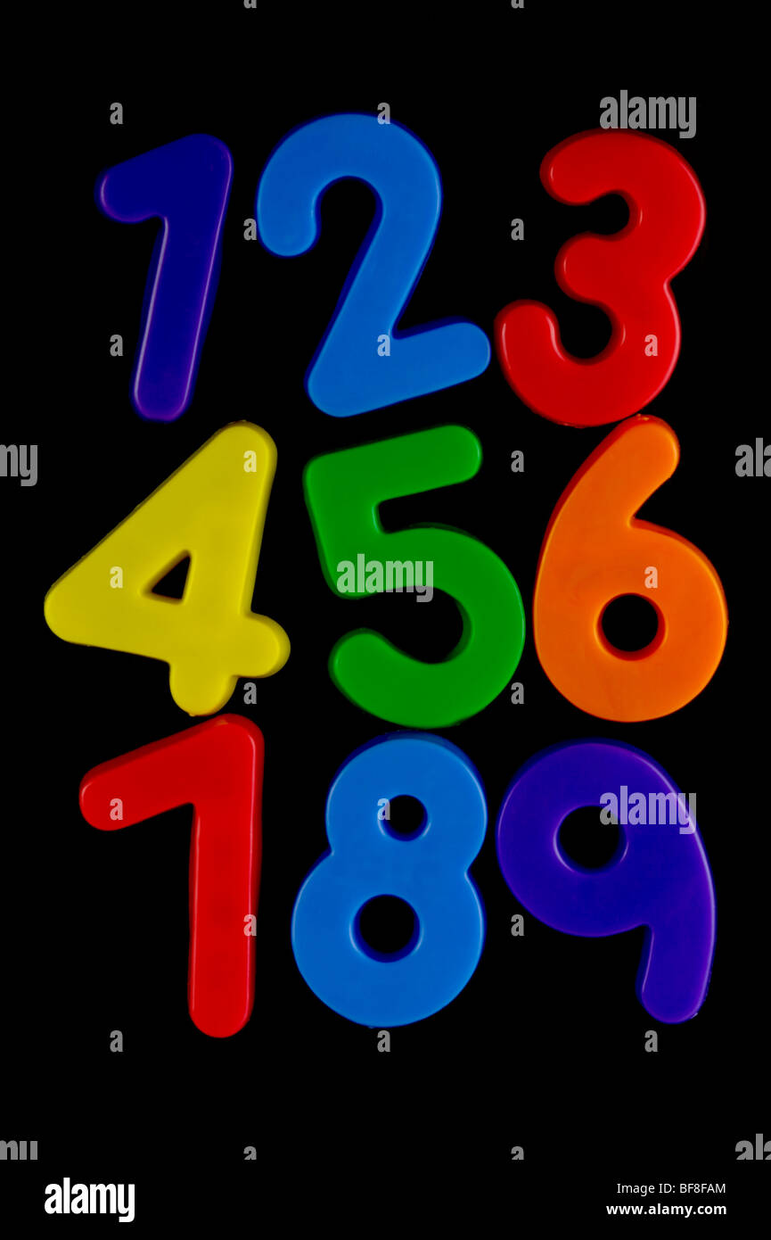 Letters and numbers of the alphabet isolated against a black background ...