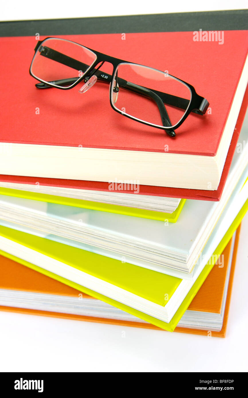Reading glasses and books isolated against a white background Stock ...