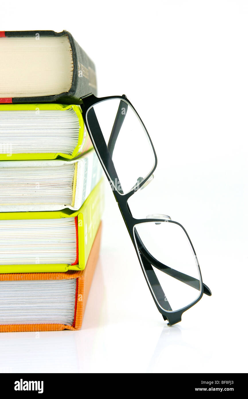 Reading glasses and books isolated against a white background Stock ...