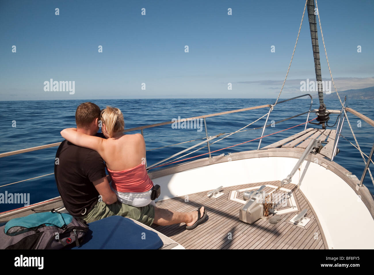A young couple relax together on a sailing yacht, Madeira Stock Photo ...