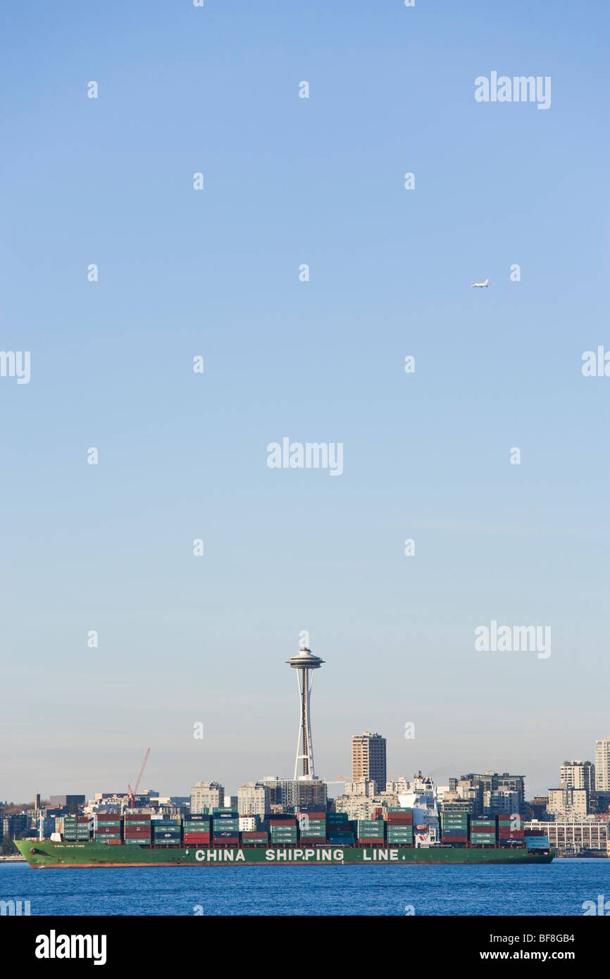 A ship full of containers on Elliott Bay below the Space Needle. An ...