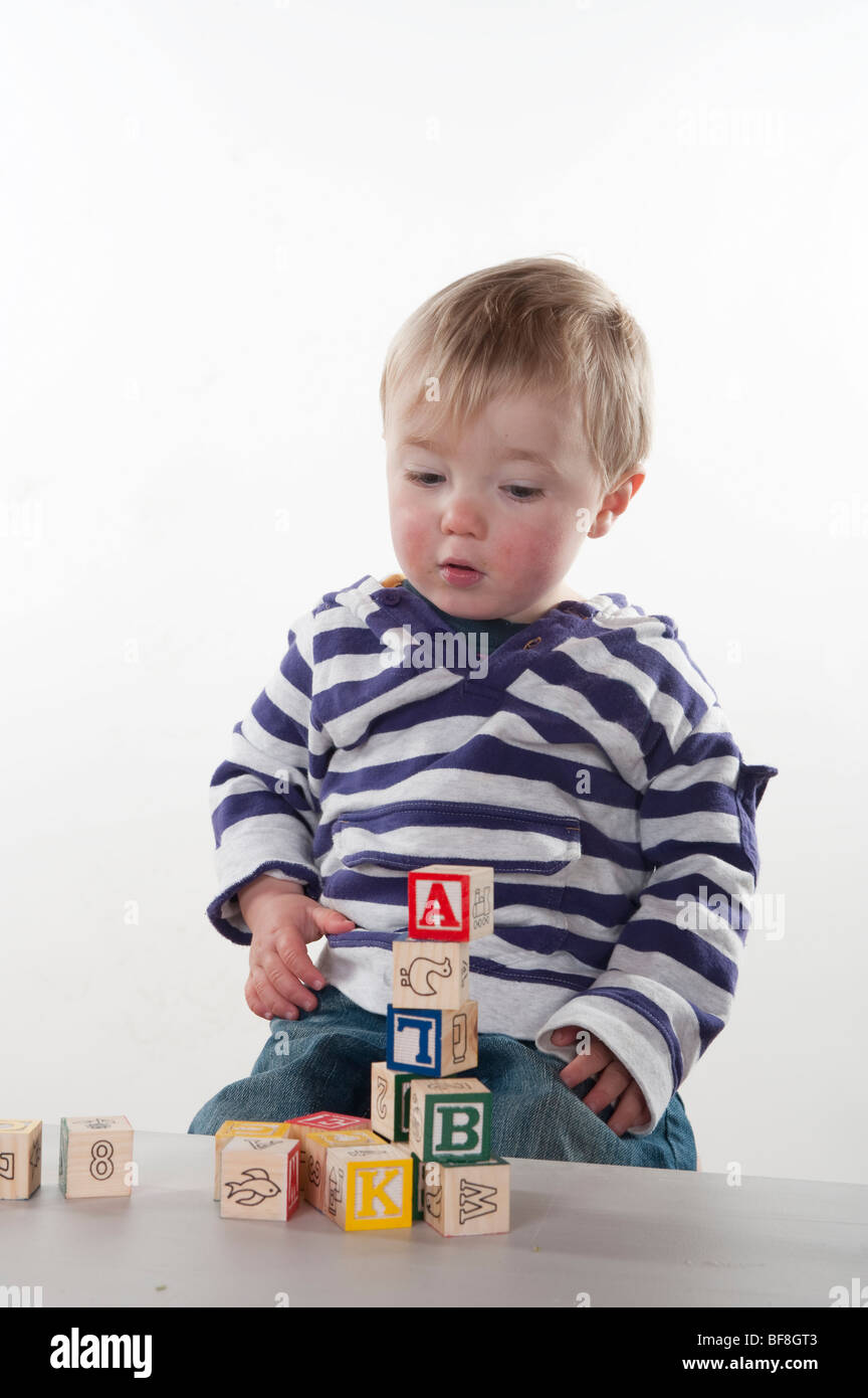 little boy playing with blocks white background Stock Photo - Alamy