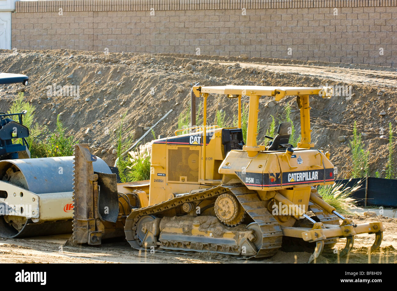 Earth moving, demolition, and pavement equipment line the side of the ...
