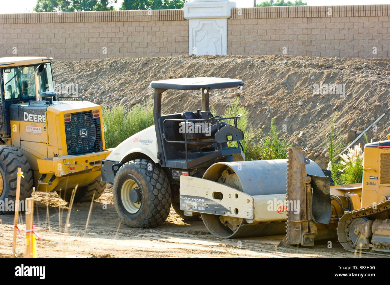 Earth moving, demolition, and pavement equipment line the side of the ...
