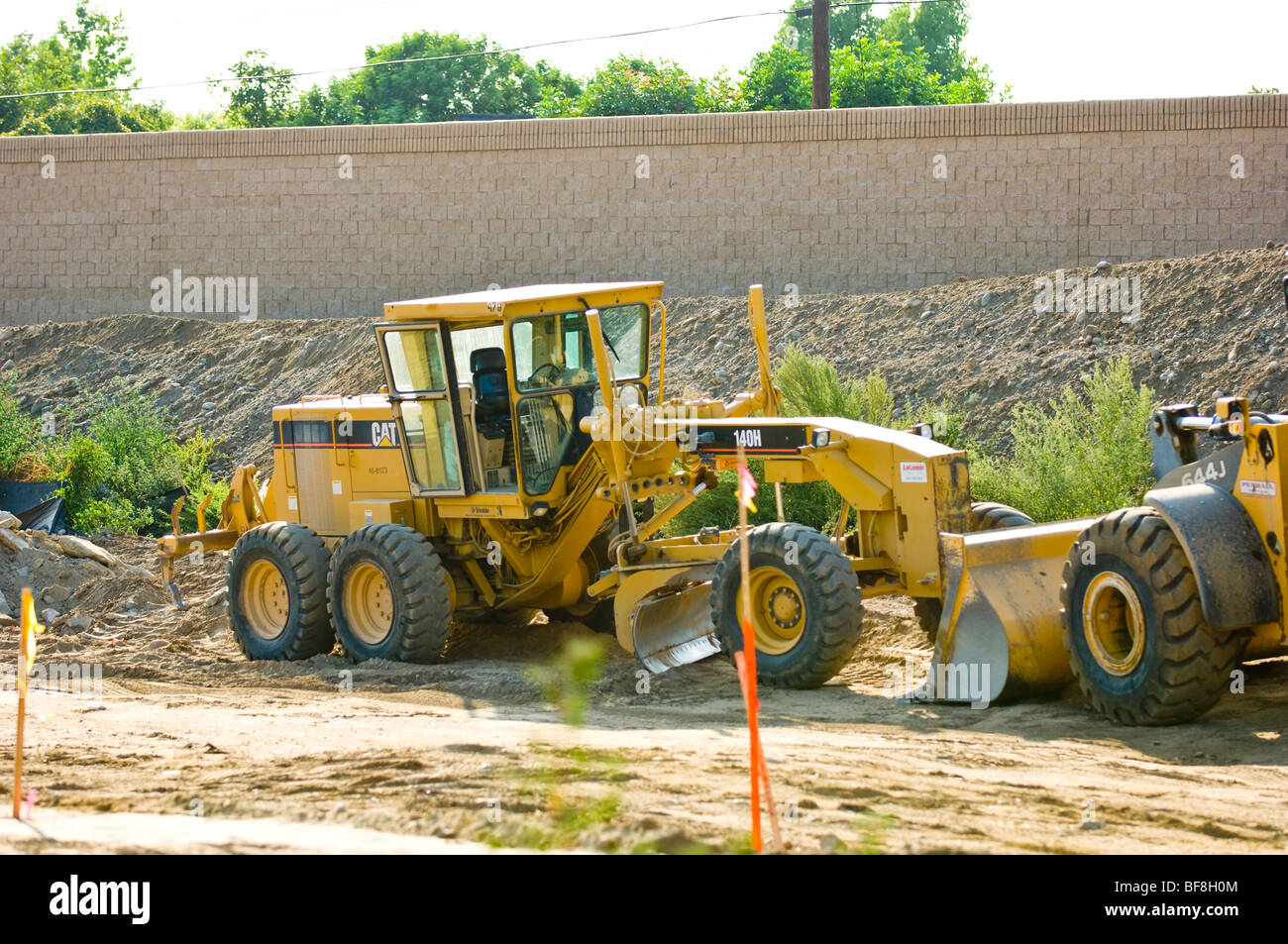 Earth moving, demolition, and pavement equipment line the side of the ...