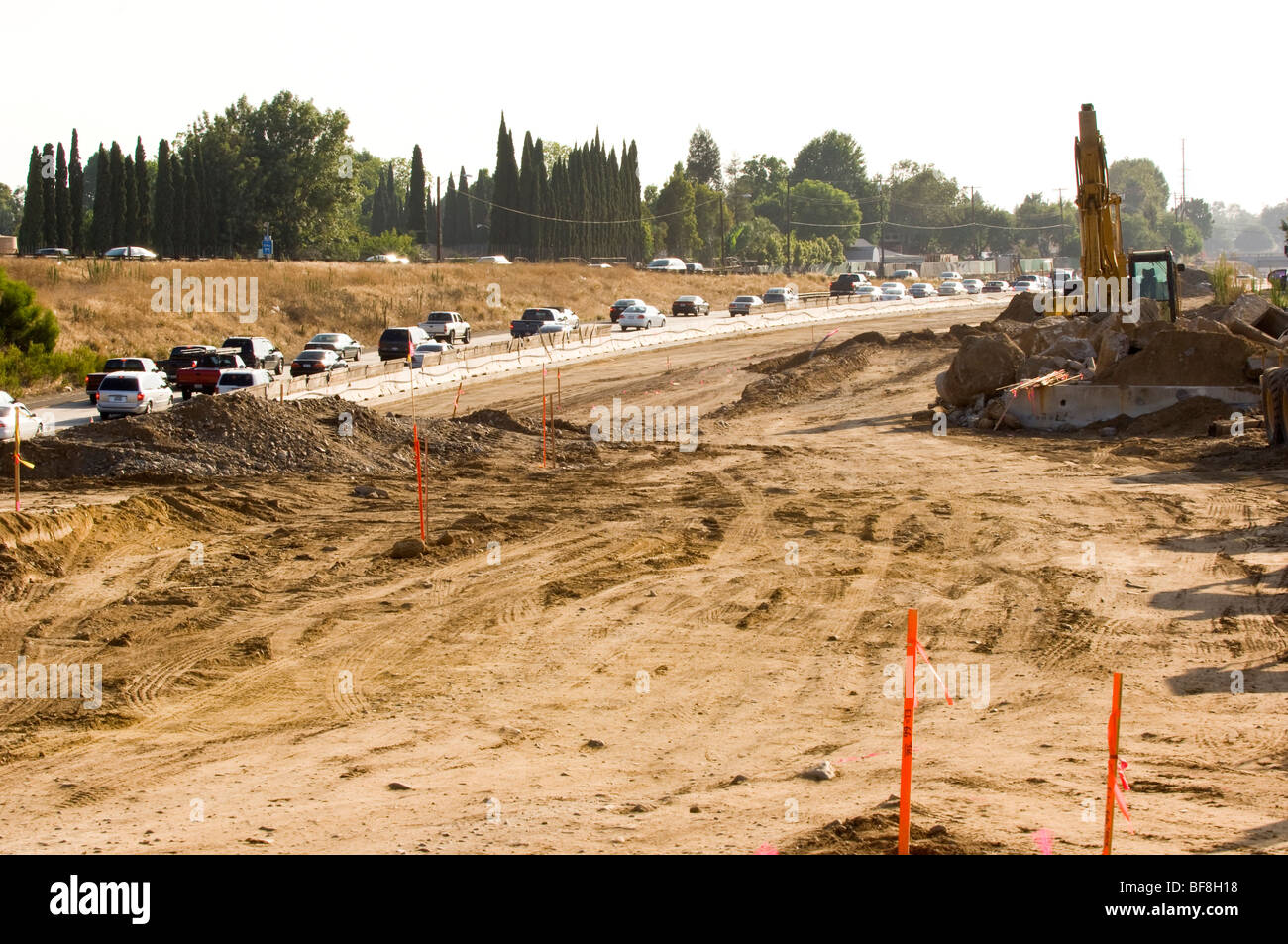 Earth moving, demolition, and pavement equipment line the side of the ...