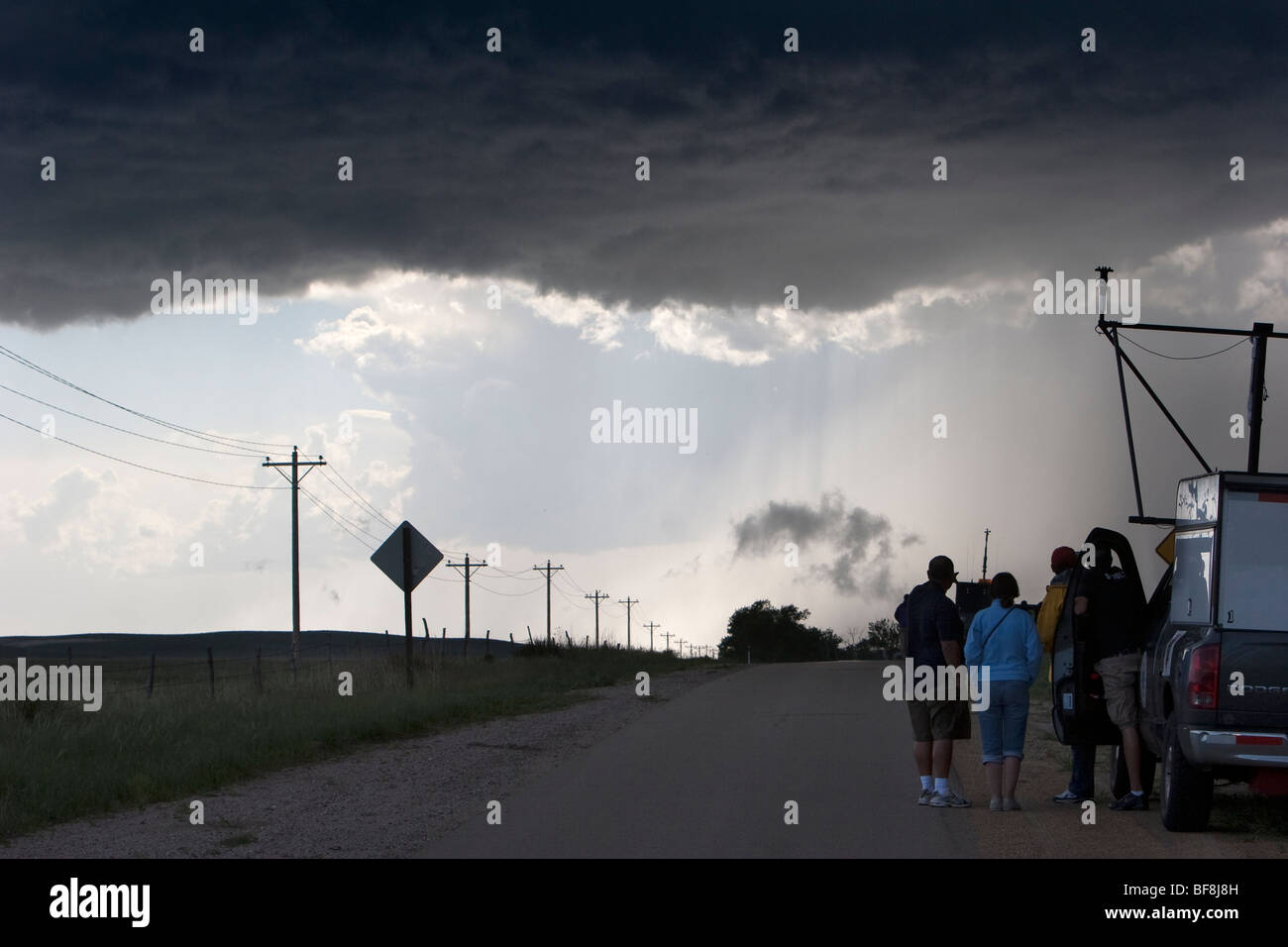 Scientists participating in Project Vortex 2 park along a road to ...