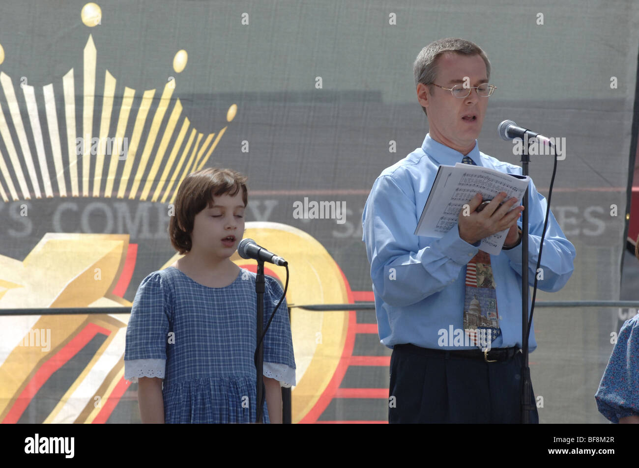Family performs choir singing and music on an outdoors stage Stock ...