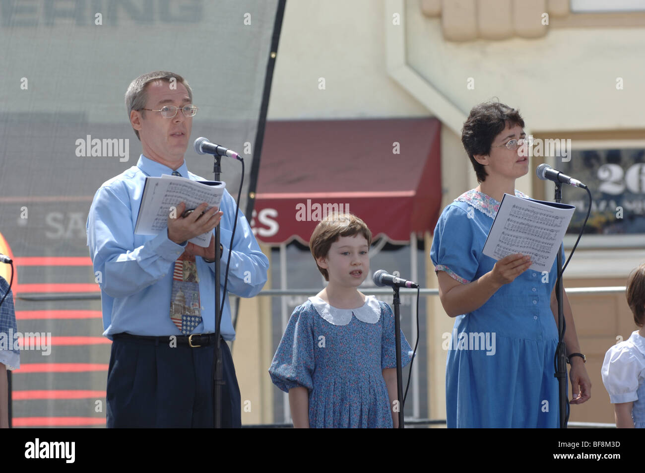 Family performs choir singing and music on an outdoors stage Stock ...