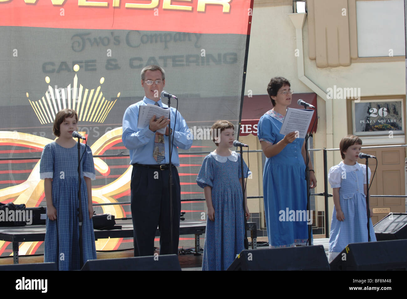 Family performs choir singing and music on an outdoors stage Stock ...