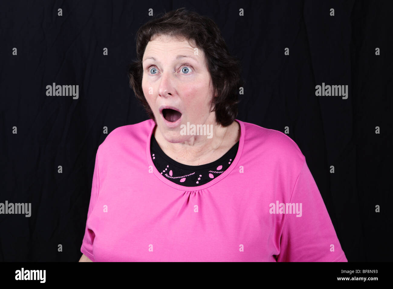 Late middle aged woman looking aghast surprised disbelieving shocked ...