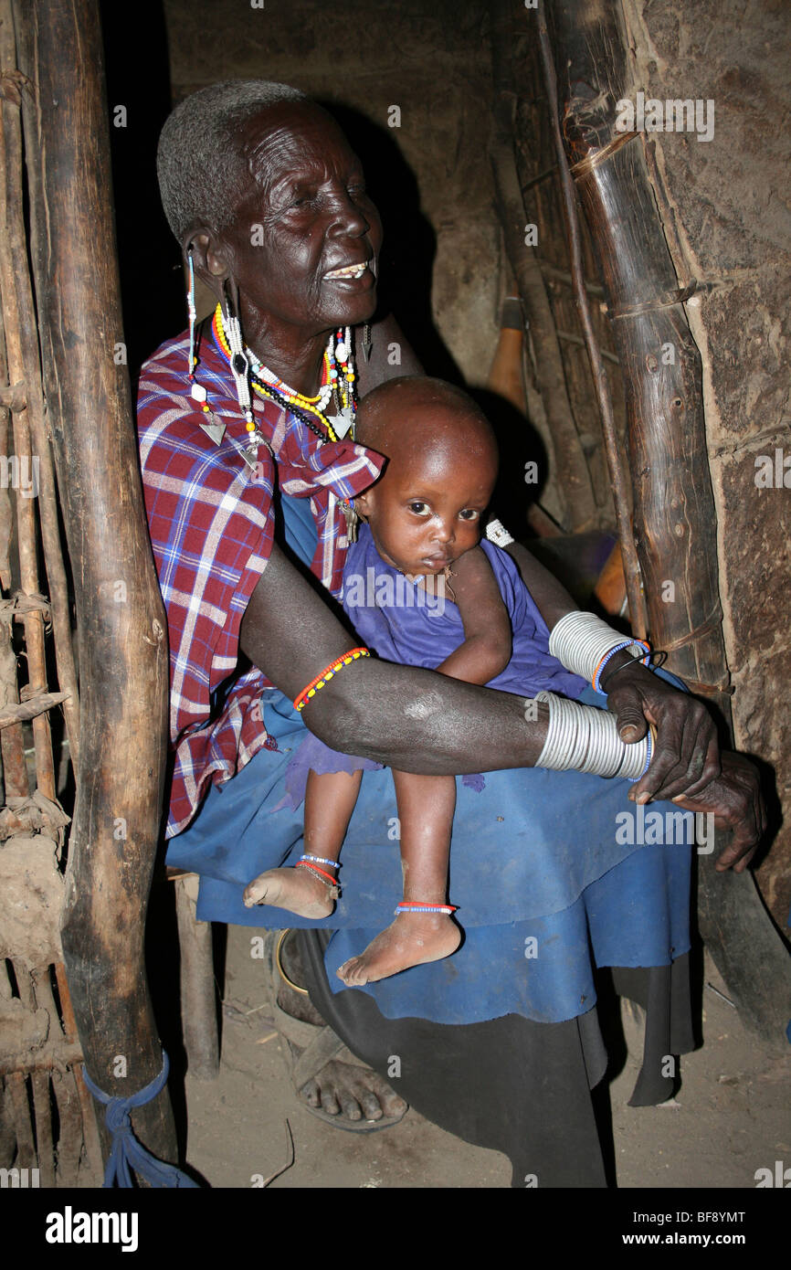 Elderly Masai Woman With Grandchild In Her Home In Engaruka Village ...