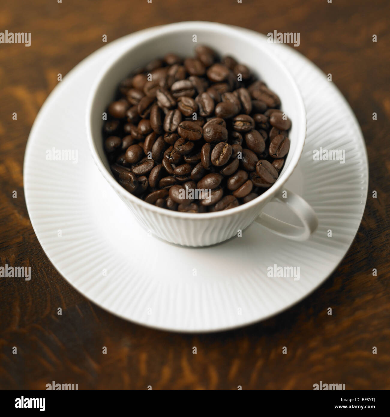 coffee cup full of coffee beans Stock Photo - Alamy