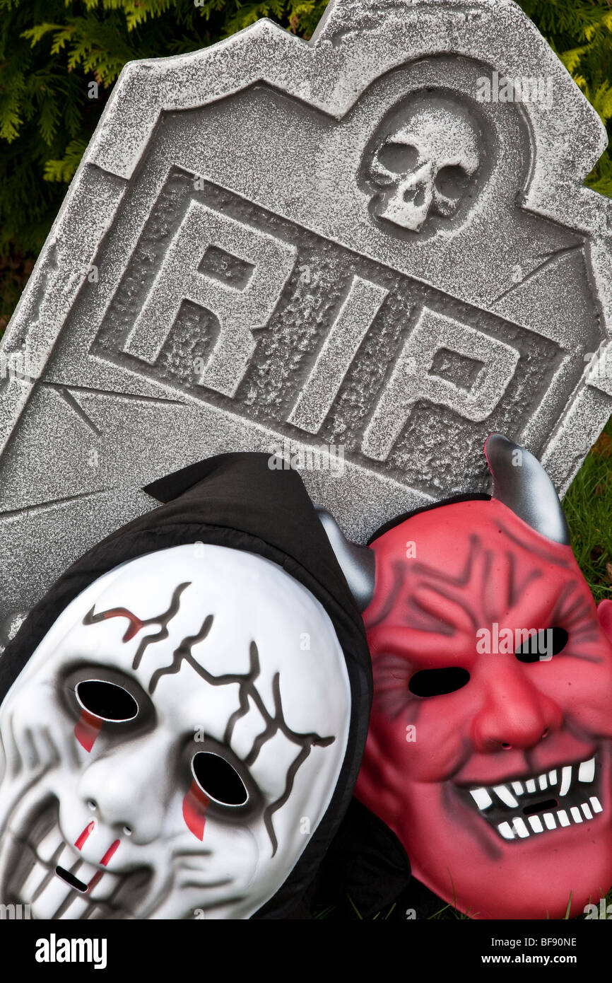Halloween mask and RIP grave headstone Stock Photo - Alamy