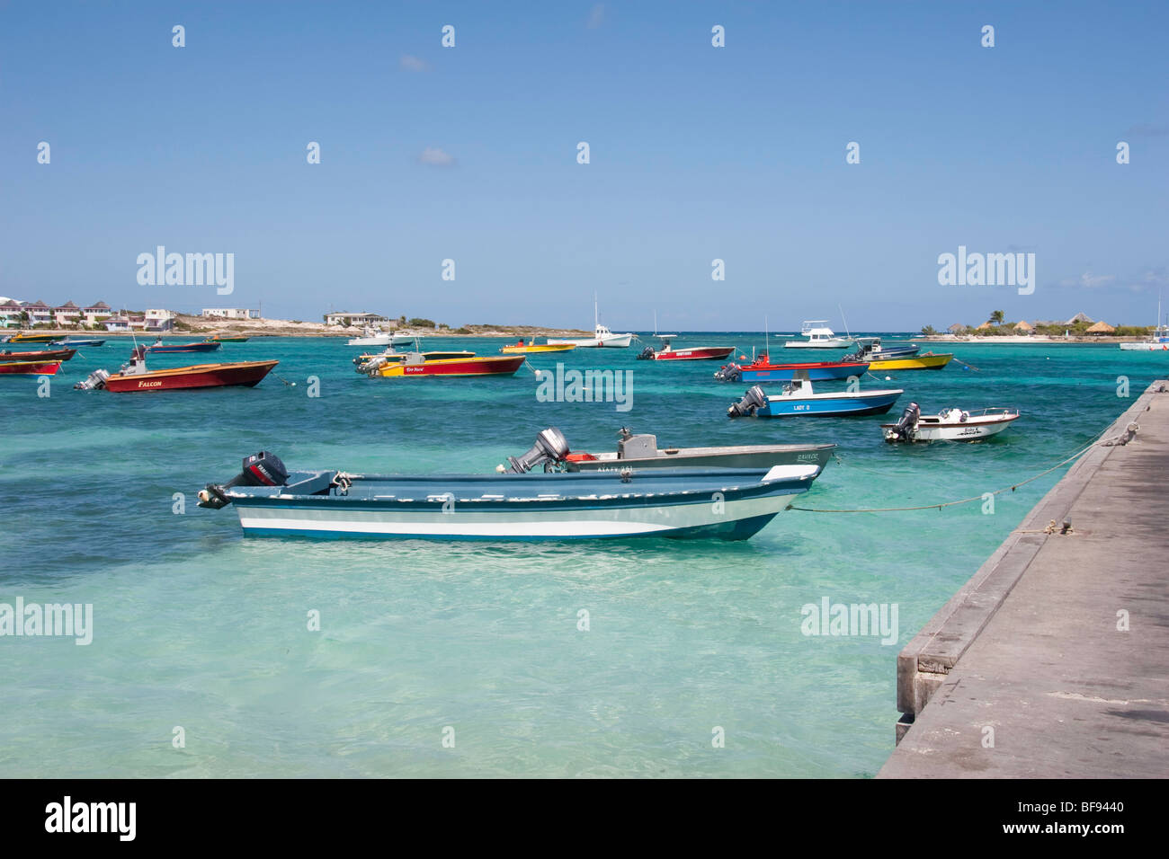 Moored fishing boats at Island Harbour, Anguilla with Scilly Cay lying ...