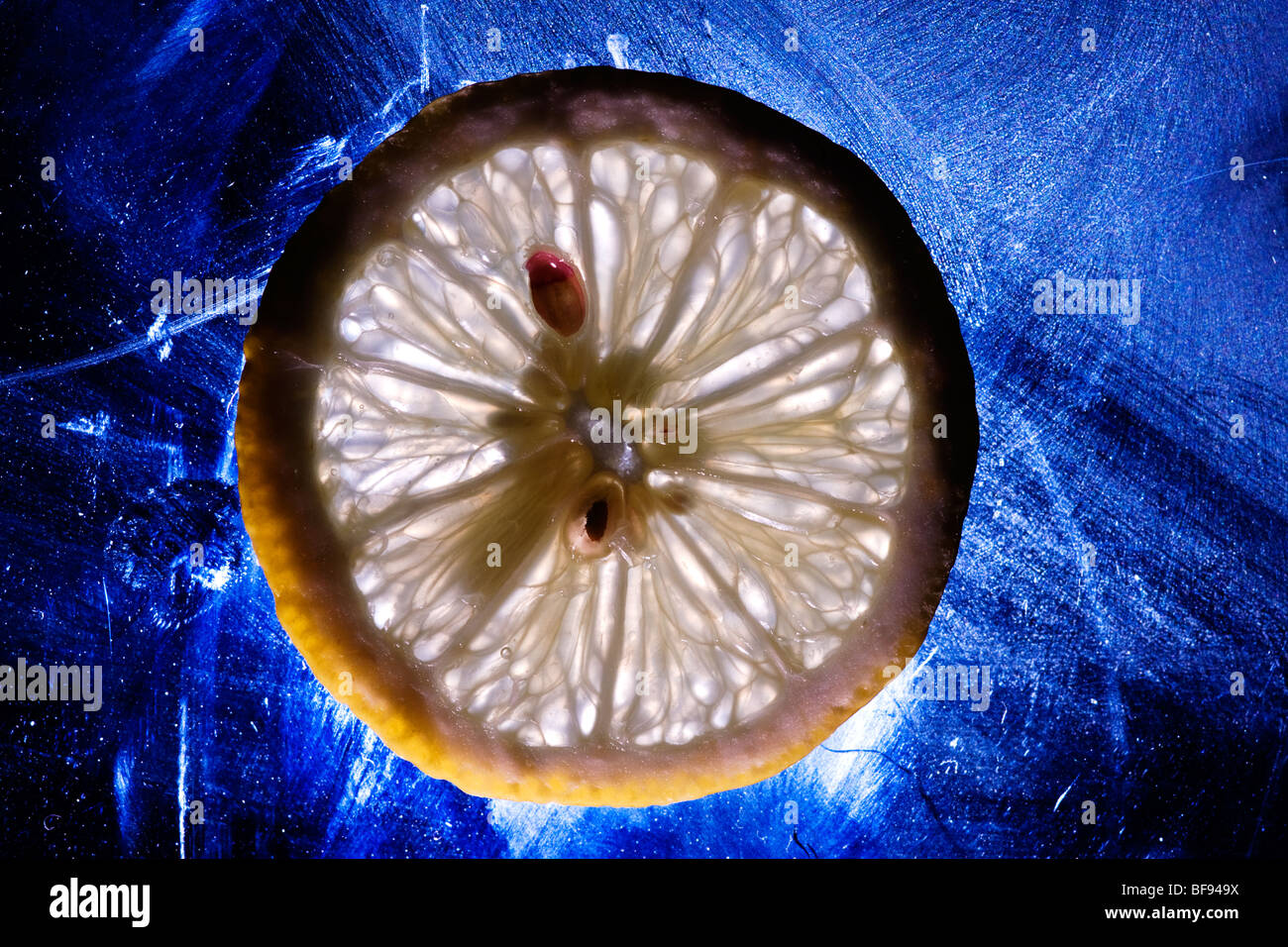 Lemon slice on blue Stock Photo - Alamy