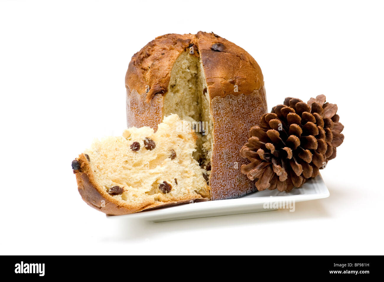 Close-up of panettone (Italian fruit cake for Christmas) and pine cone ...