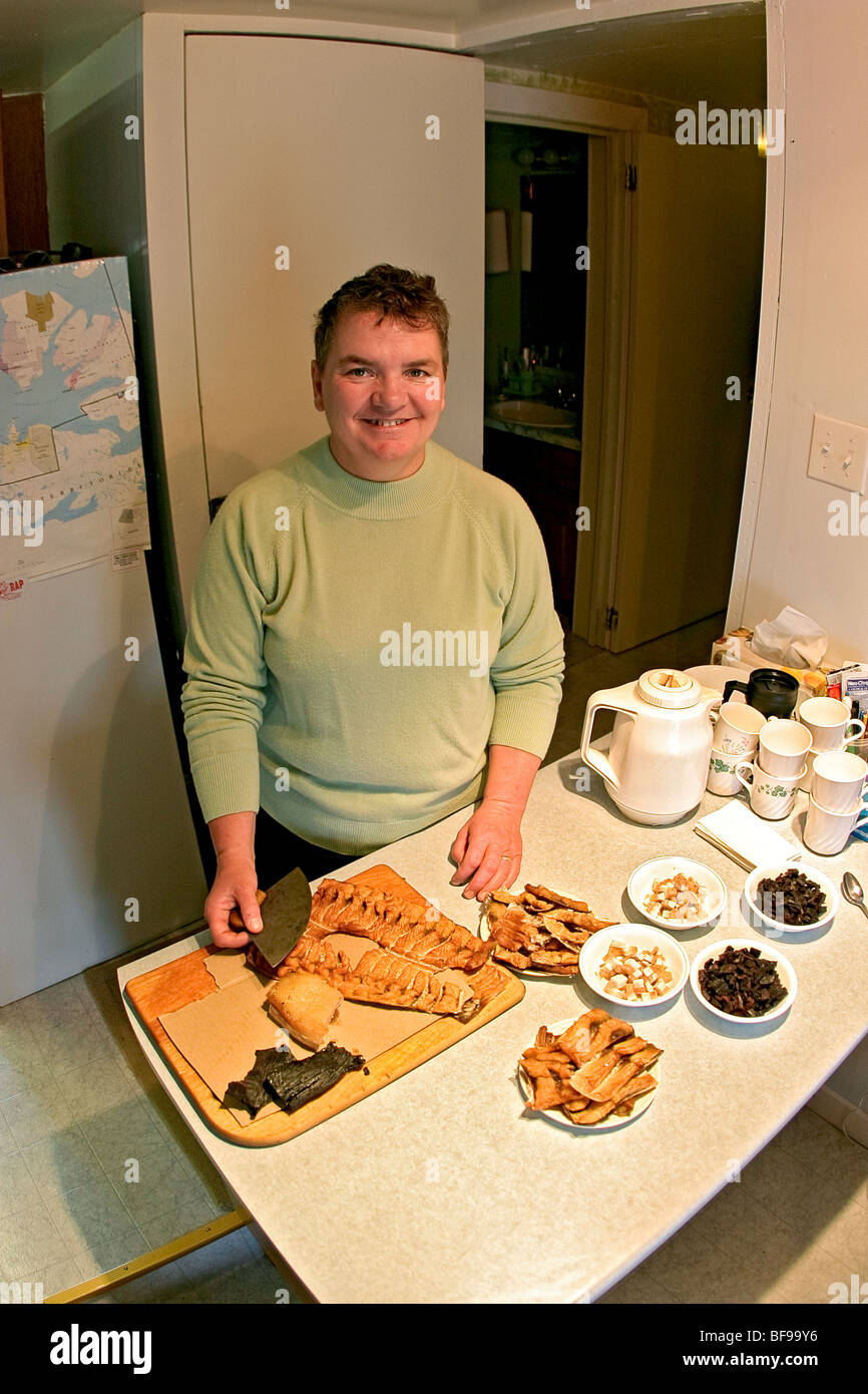 Local woman serves traditional food (dried whale, dried fish, muktuk ...