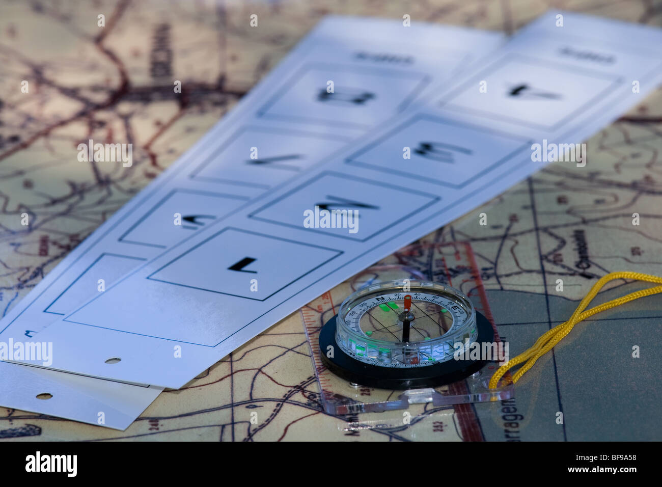 Compass with a map on the back ground Stock Photo - Alamy