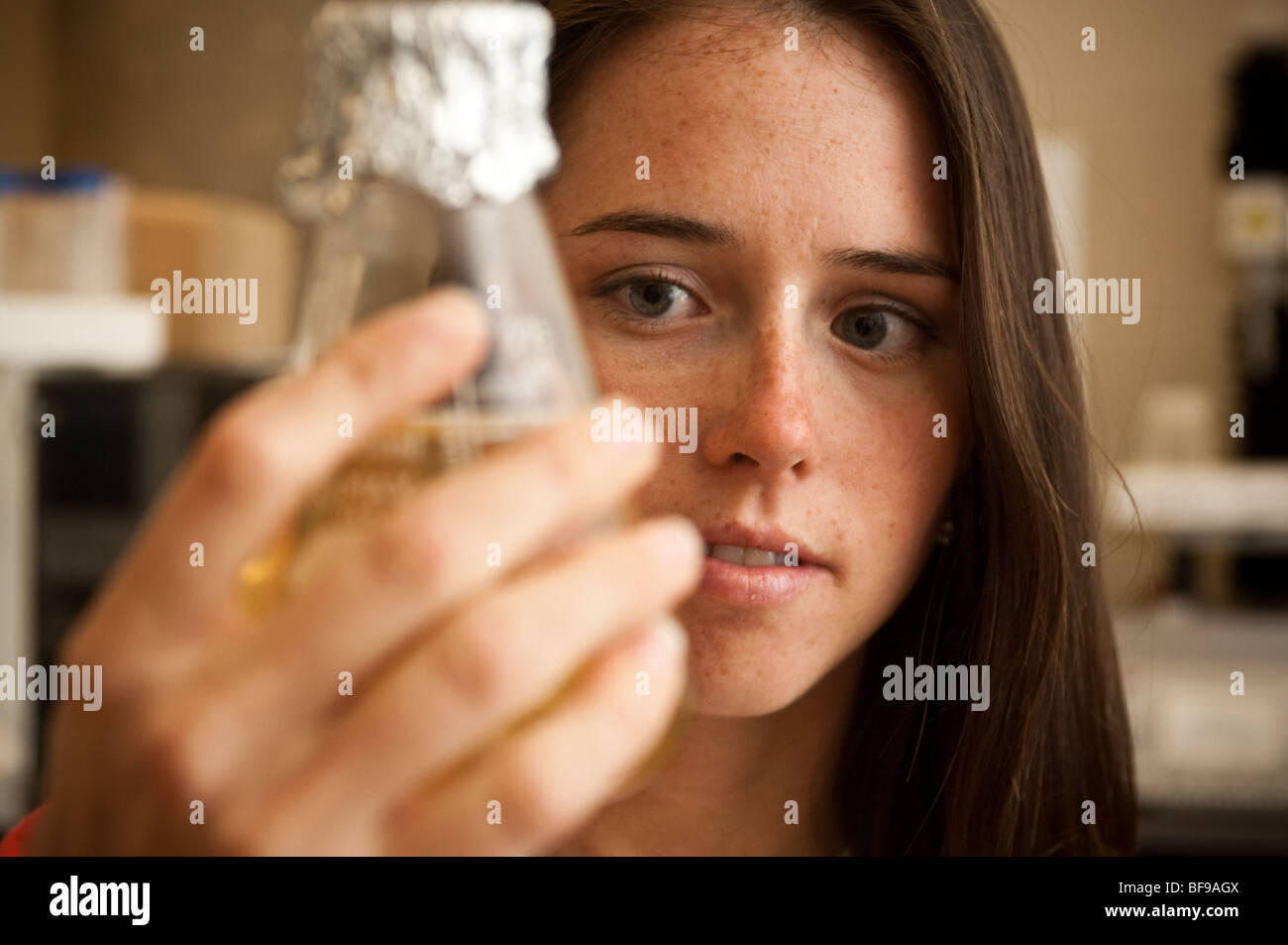 student in lab observing beaker Stock Photo - Alamy