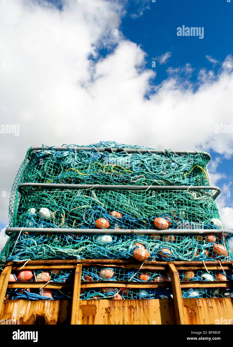 colourful commercial fishing nets piled up on a rusty trailer in Dingle ...