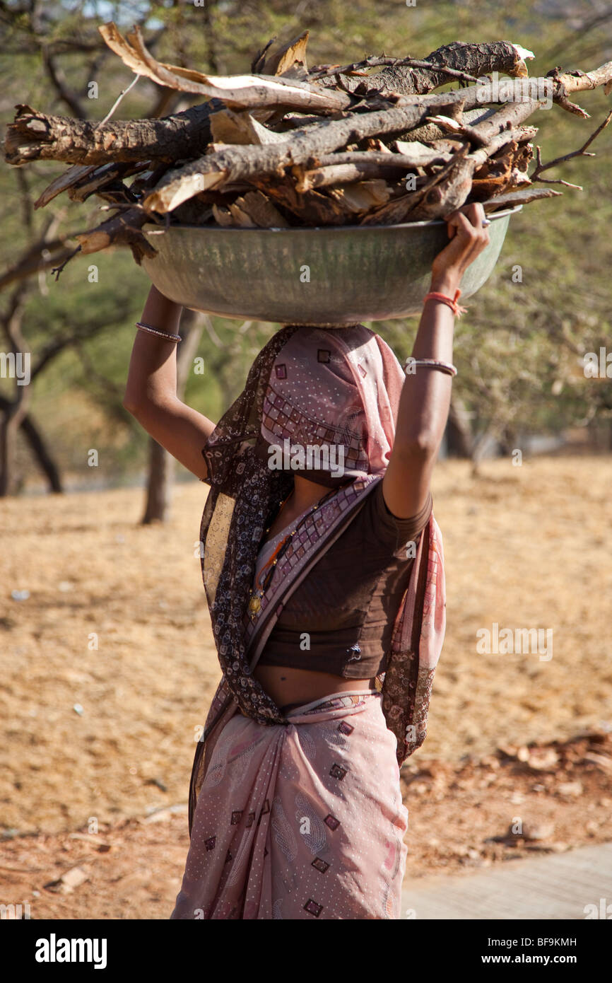 Woman balancing firewood on her head hi-res stock photography and ...