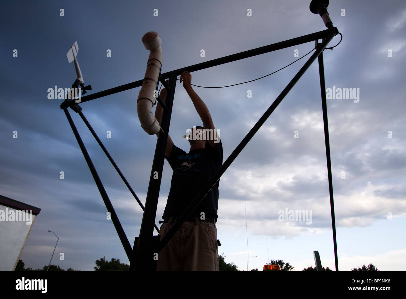 A scientist with Project Vortex 2 adjusts weather instrumentation on ...