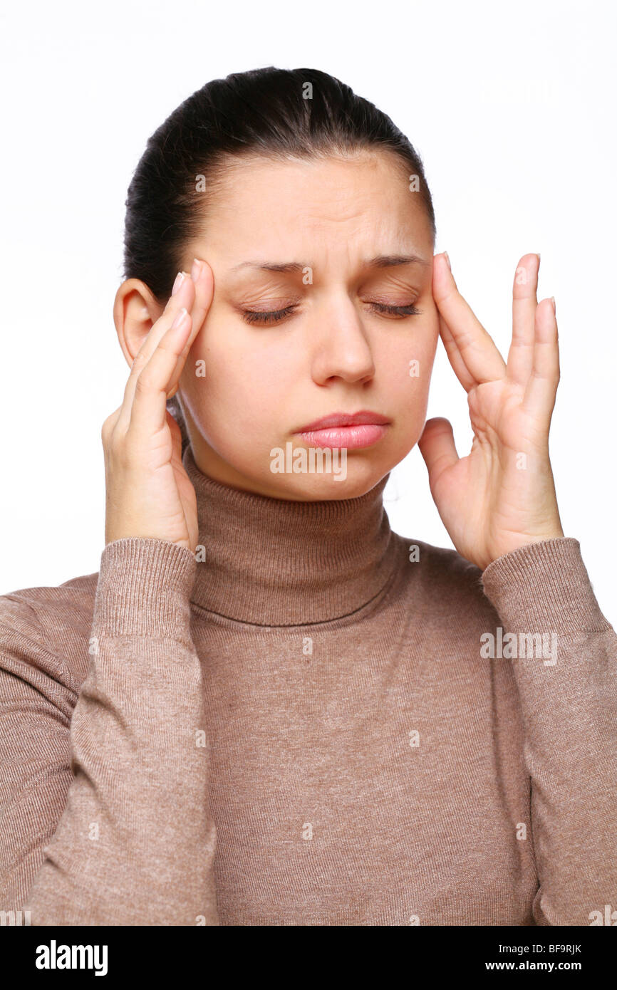 Sad young woman has a headache and massages her temples by fingers ...