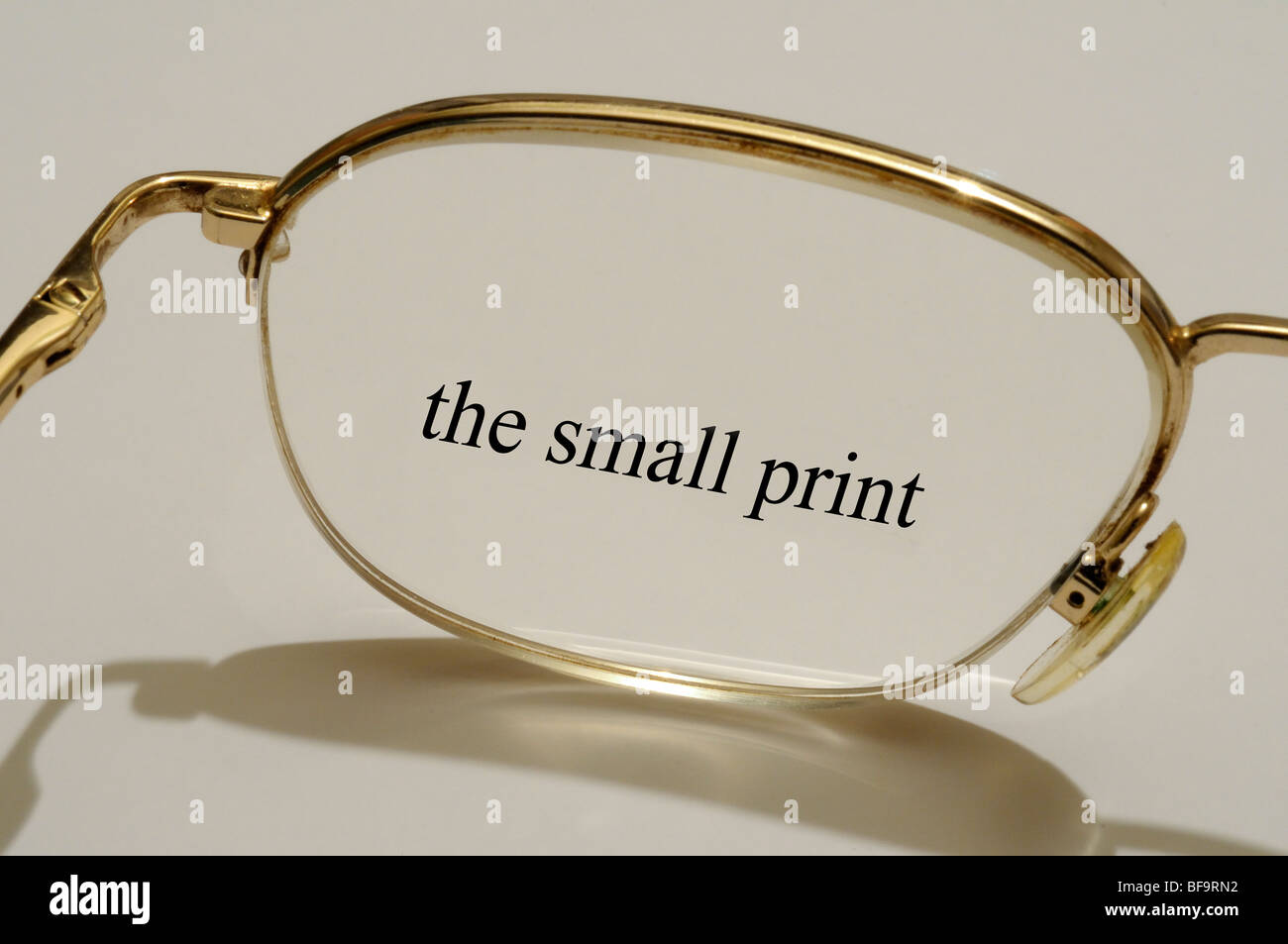 Read the small print in spectacles Stock Photo - Alamy