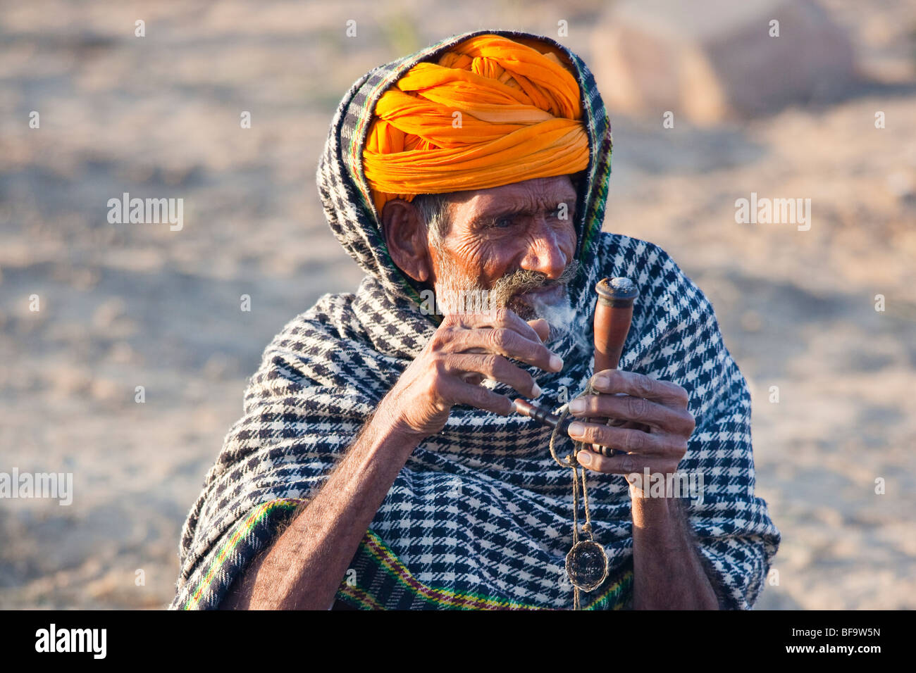 Camel man smoking a pipe at the Camel Fair in Pushkar India Stock Photo ...