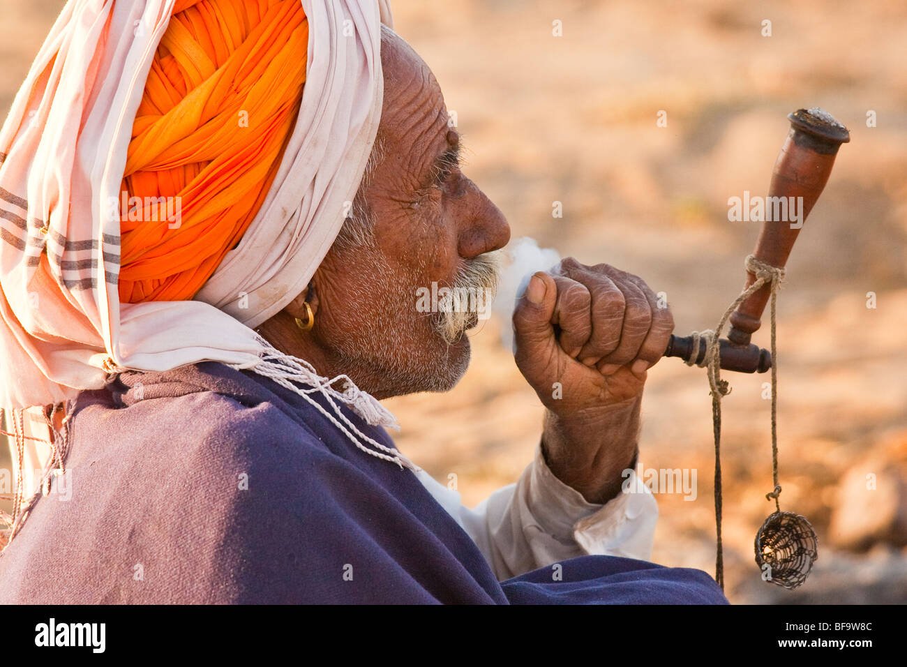 Camel man smoking a pipe at the Camel Fair in Pushkar India Stock Photo ...