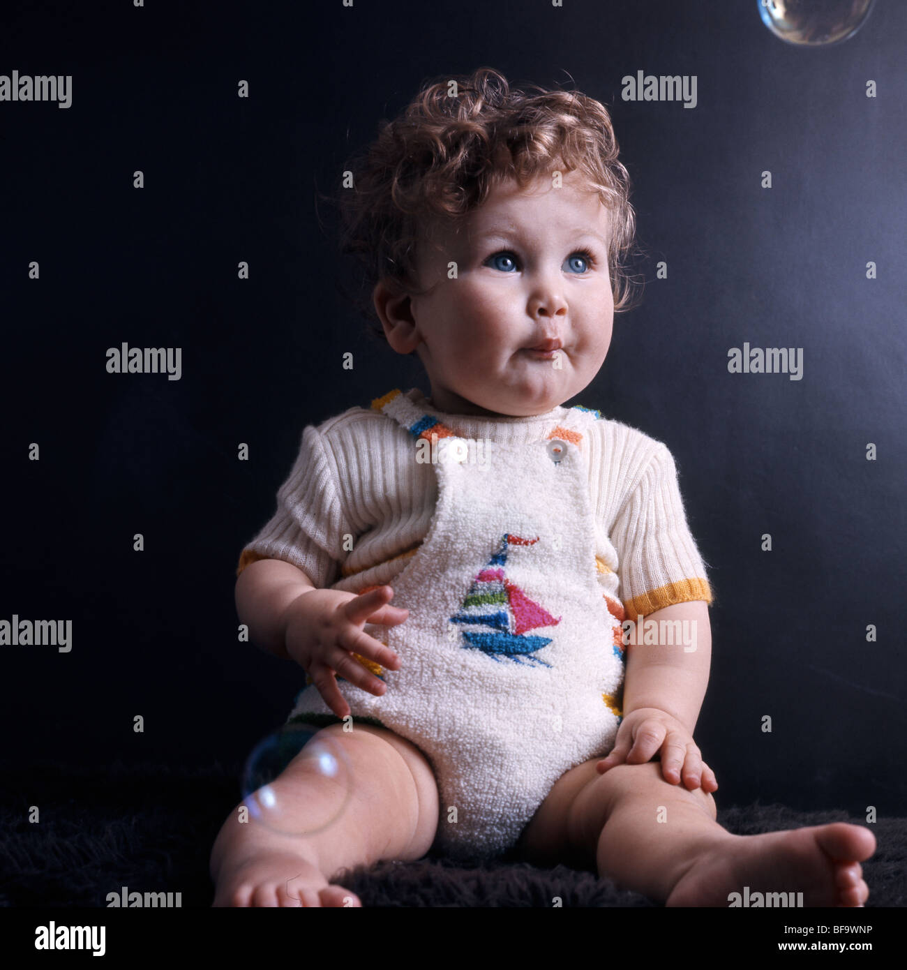 Baby boy fascinated by bubbles Stock Photo - Alamy