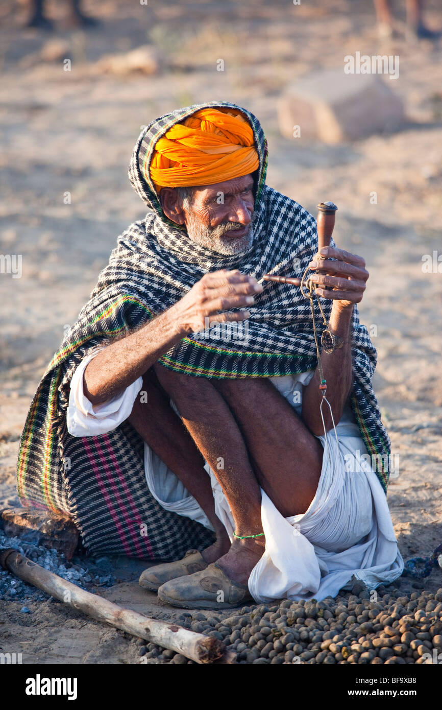Camel man smoking a pipe at the Camel Fair in Pushkar India Stock Photo ...