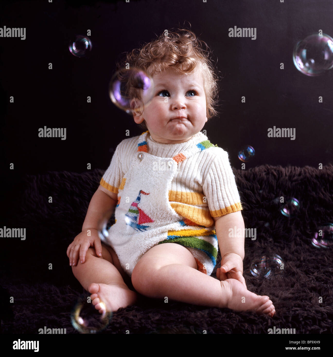 Baby boy fascinated by bubbles Stock Photo - Alamy