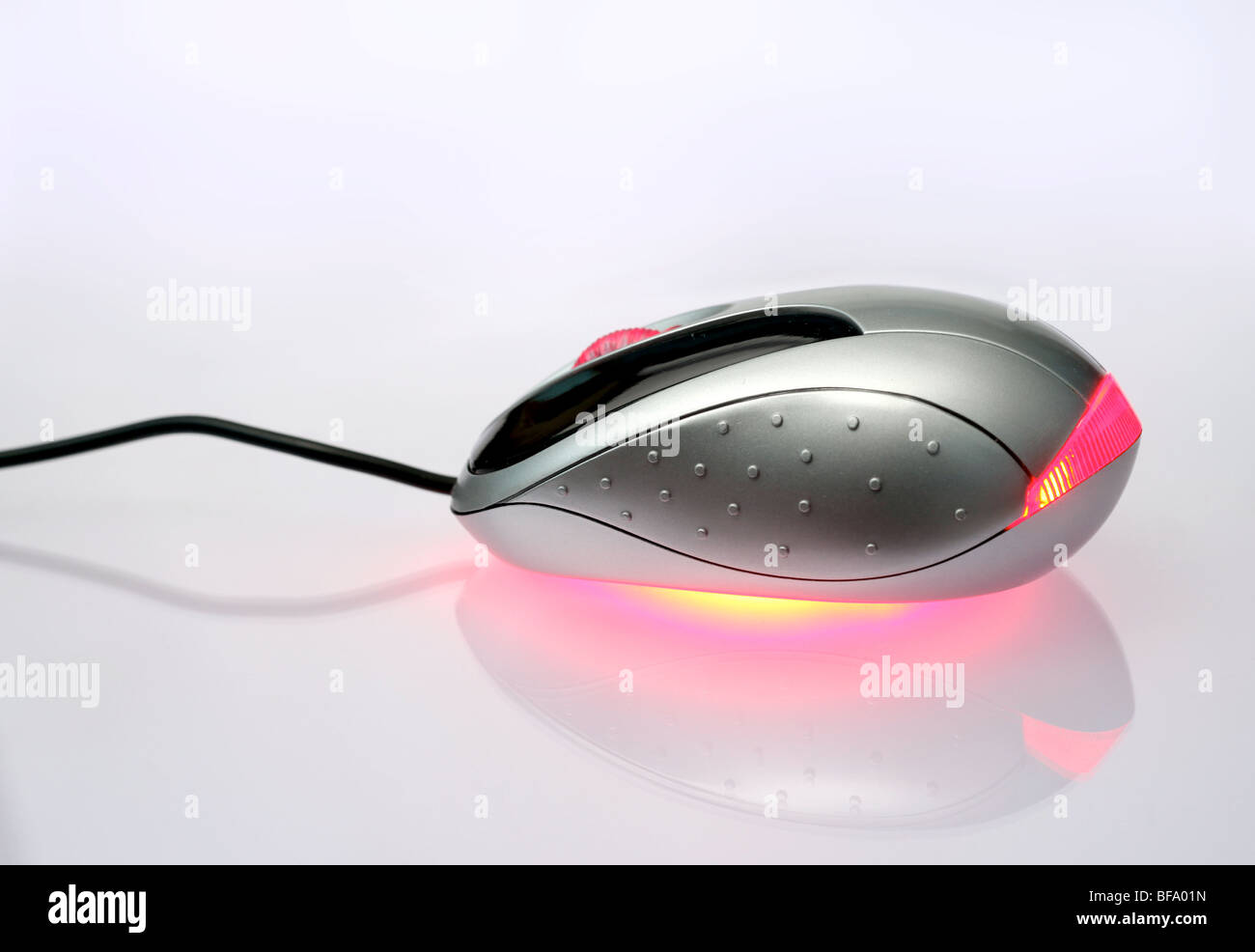 An optical wheel mouse, side view, with its reflection. The colour is ...