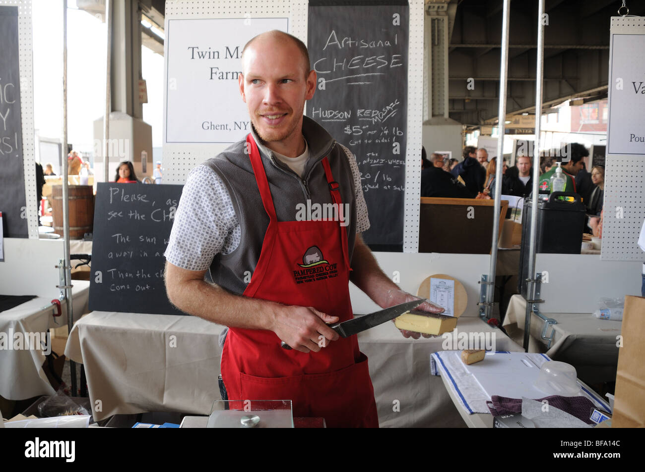 A cheesemaker from upstate New York sells his cheese at a farmers ...