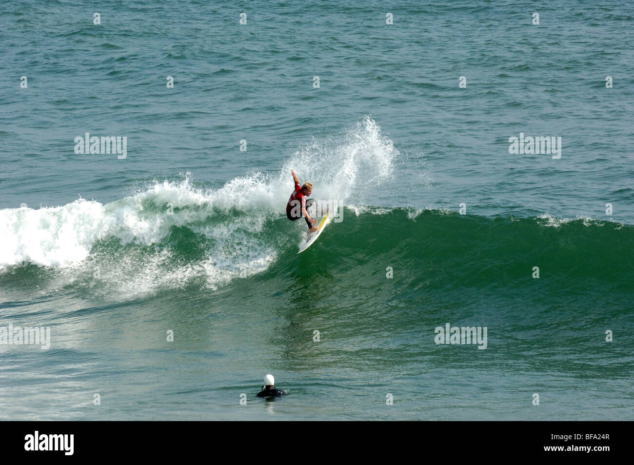 A partially submerged cameraman operates his waterproof camera system ...