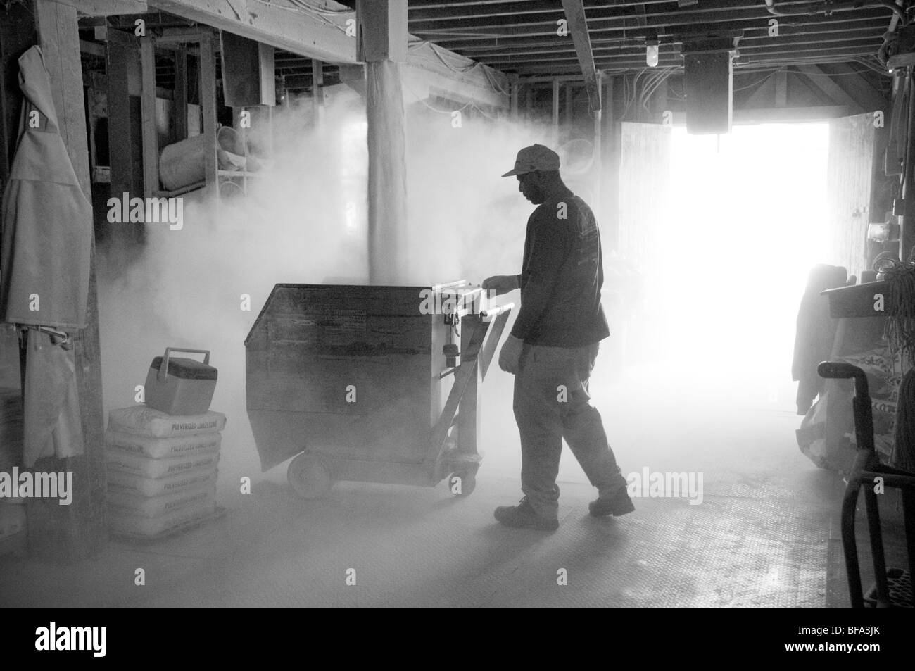 Worker in feed mill Stock Photo - Alamy