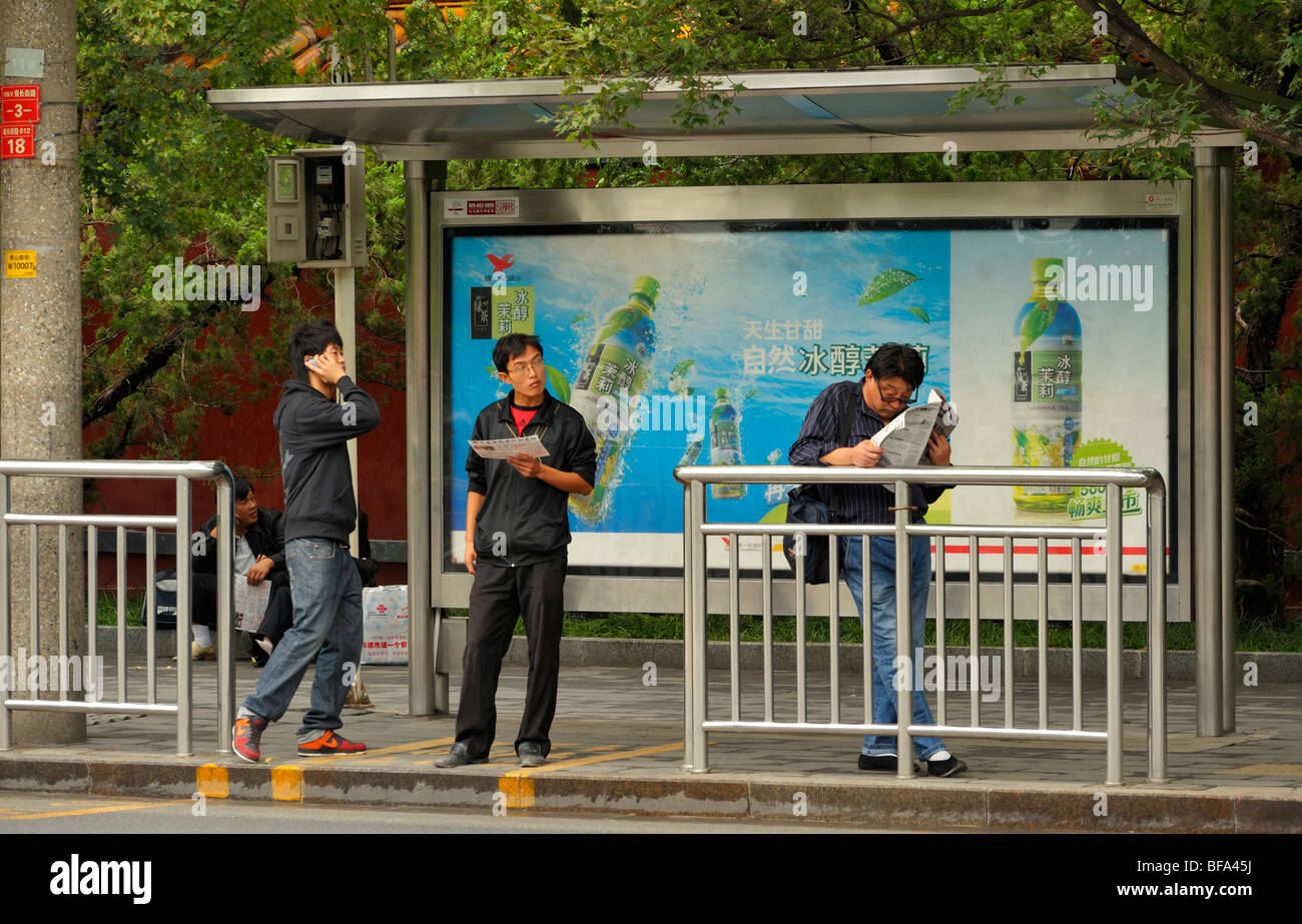 Reading newspaper bus stop hi-res stock photography and images - Alamy